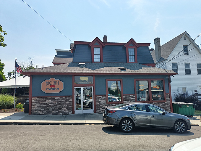 A closer look at Bigham Tavern's welcoming storefront, where the pig silhouette hints at the porky delights that await hungry visitors.