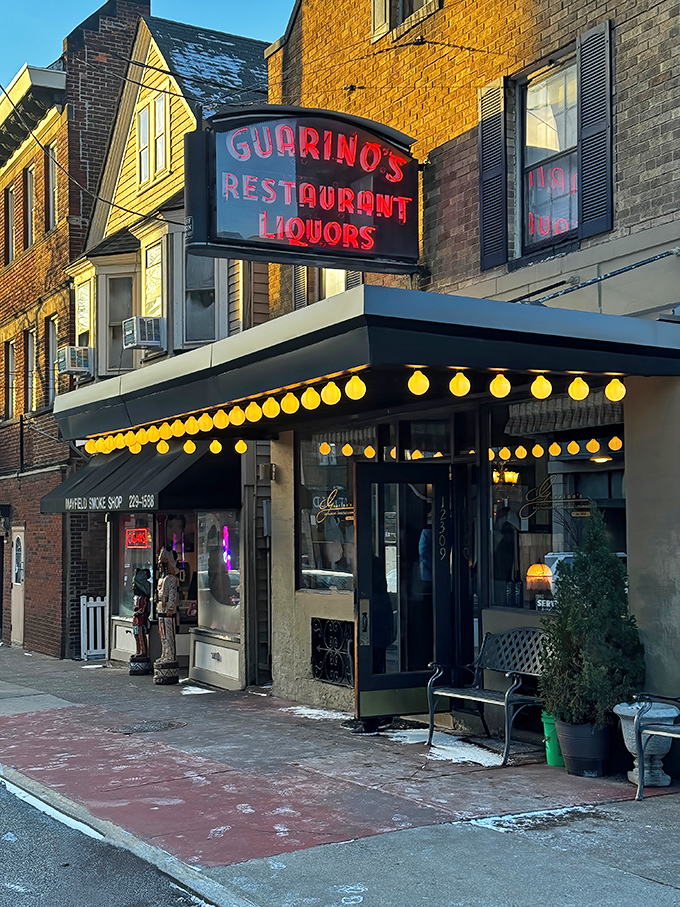 When the sun sets, Guarino's neon sign glows like a warm invitation, those charming string lights promising an evening of culinary nostalgia.