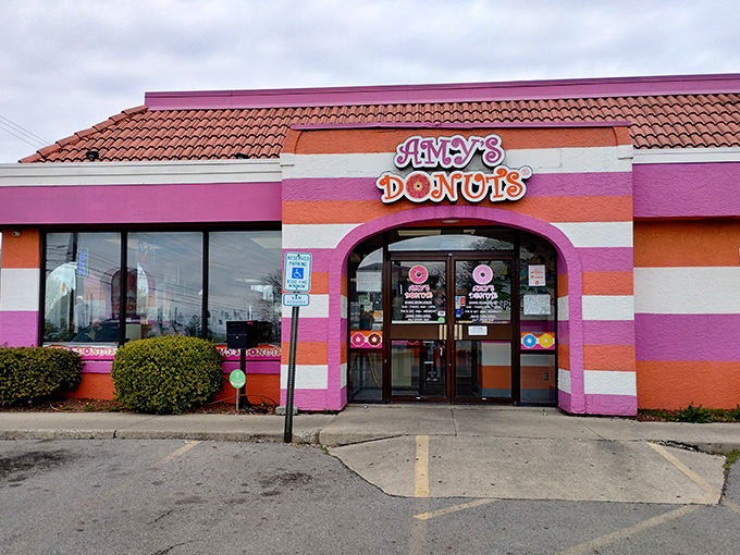 The pink and orange striped exterior of Amy's Donuts isn't just a building—it's a mood-altering visual promise that something wonderfully indulgent awaits inside.