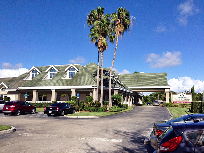 The ultimate Florida plot twist: palm trees framing an Amish restaurant. Der Dutchman's green-roofed charm stands ready to welcome hungry pilgrims.