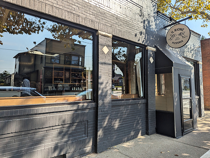 The unassuming gray exterior of Il Rione hides pizza greatness within, like Clark Kent's glasses concealing Superman's true identity.