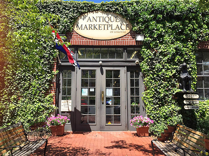 The ivy-embraced entrance to the Antique Marketplace of Lemoyne beckons like a time portal disguised as a charming brick building.