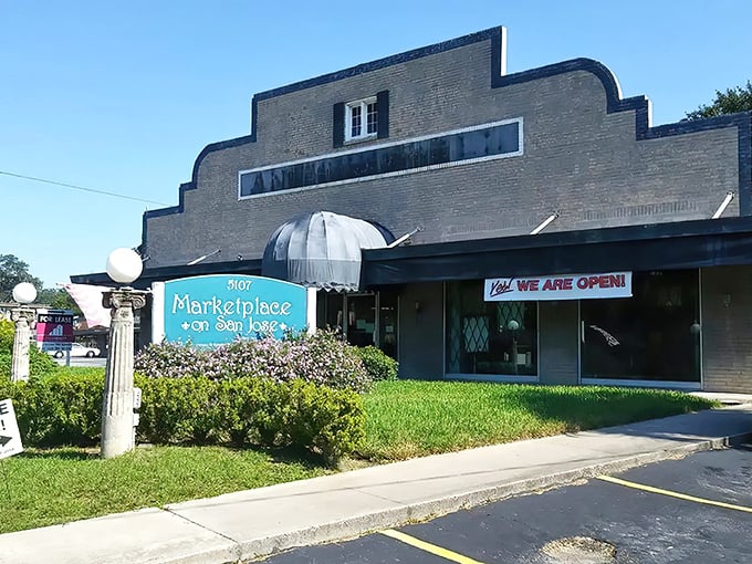 The stepped Art Deco facade of Marketplace on San Jose beckons like a time portal disguised as architecture. Florida sunshine highlights every charming brick detail.