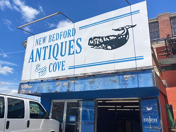 The blue exterior and whale-adorned sign of New Bedford Antiques at the Cove stand like a time capsule waiting to be explored.