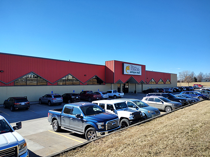 The red fortress of forgotten treasures beckons from the roadside, promising adventures through time rather than just shopping.