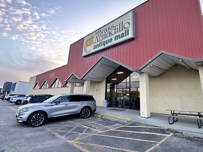 The iconic red exterior of Brass Armadillo welcomes treasure hunters with its distinctive armadillo logo&mdash;Nebraska's portal to the past.