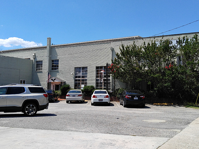The unassuming exterior of Old Mill Antique Mall stands like a time capsule waiting to be opened, with its simple signage belying the treasures within.