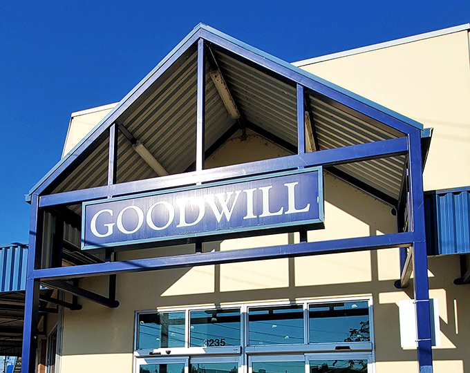 The unassuming facade of Salem's Goodwill Outlet belies the treasure-hunting adventure that awaits inside. Blue skies overhead seem to promise good fortune.