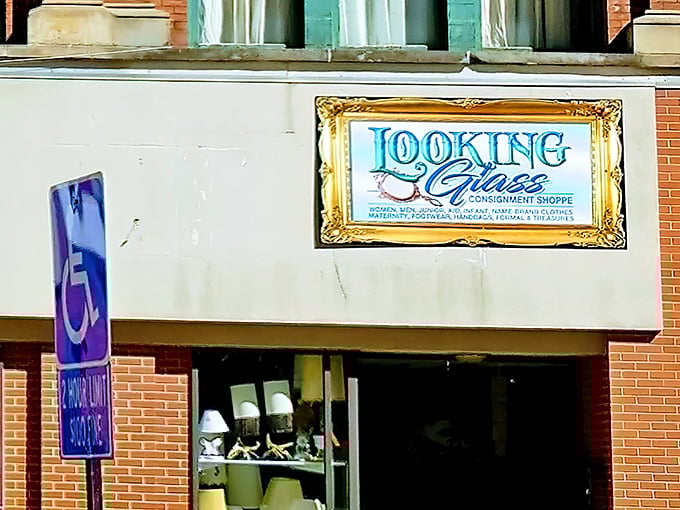 The Looking Glass Consignment storefront beckons with its whimsical sign, promising adventures in treasure hunting behind that unassuming brick facade.