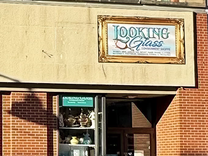 The unassuming storefront of Looking Glass Consignment beckons with promises of treasures waiting just beyond that brick facade.