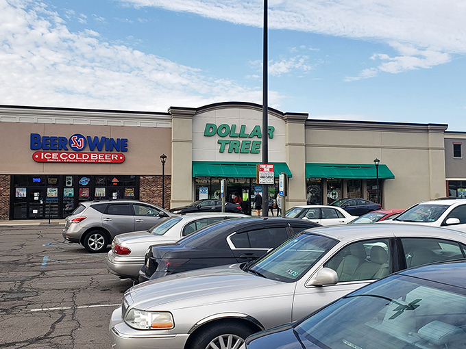 That familiar green and white storefront promises affordable adventures waiting just beyond those automatic doors.