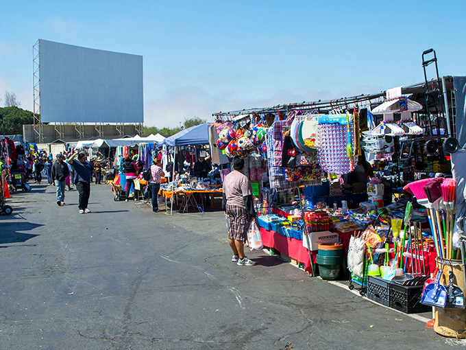 The Coronado Swap Meet stretches out like a bargain hunter's paradise, with the iconic drive-in screen standing sentinel over a sea of treasures.