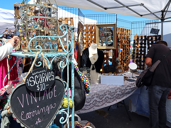 A treasure trove of vintage accessories awaits! This booth's turquoise display rack showcases scarves and jewelry that whisper stories from decades past.