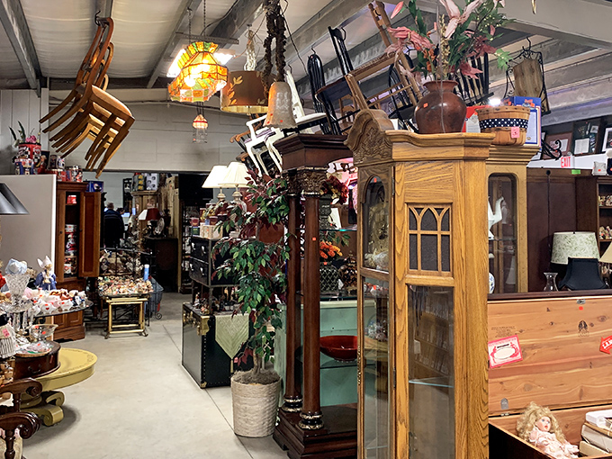 Furniture heaven meets vintage wonderland. That oak cabinet has probably witnessed more history than most history books, while chairs dangle playfully from the ceiling.