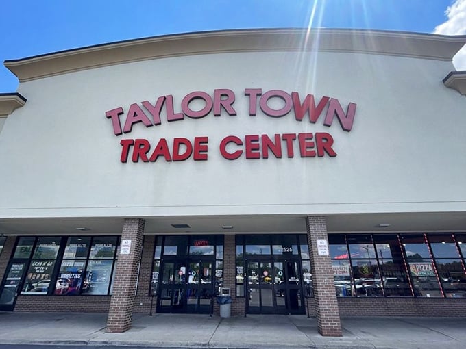 The iconic red signage of Taylor Town Trade Center beckons bargain hunters like a retail lighthouse guiding ships to treasure-filled shores.
