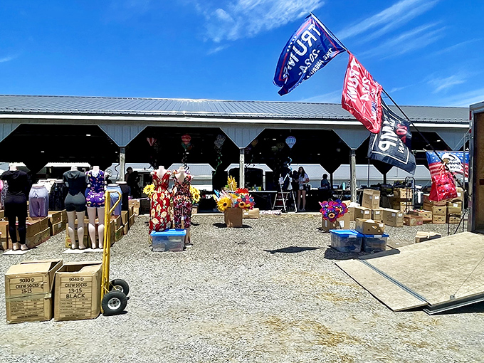 Flags flutter above a sea of merchandise, where mannequin legs model socks while cardboard boxes promise undiscovered treasures.