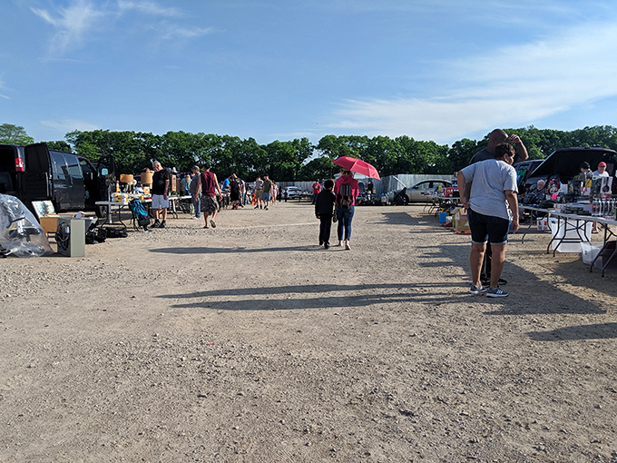 Early birds catch the deals at South Drive-In's flea market, where treasure hunters navigate rows of vendors under Columbus's big blue sky.