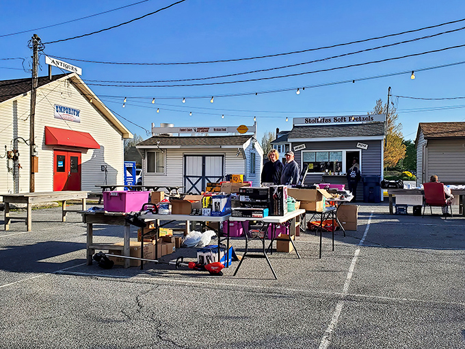Treasure hunting begins here! Outdoor tables laden with potential finds await under the watchful eye of Root's charming storefronts.