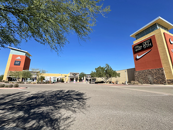 The towers of retail temptation rise above the desert landscape, beckoning bargain hunters like modern-day sirens.