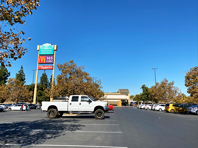 The iconic entrance sign welcomes bargain hunters like a retail promised land under California's impossibly blue skies.