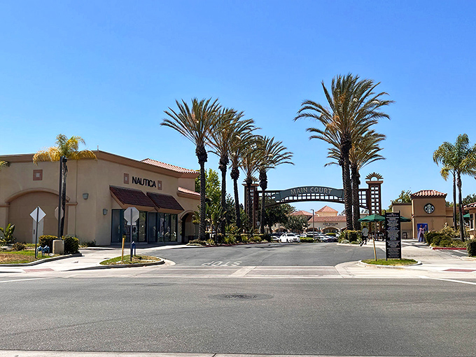 Palm trees stand sentinel at this shopping paradise, where California sunshine meets designer discounts in perfect retail harmony.