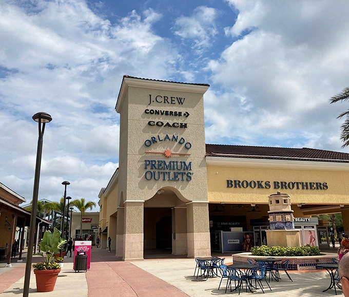 The iconic entrance to Orlando Premium Outlets, where credit cards come to dance and wallets come to diet.