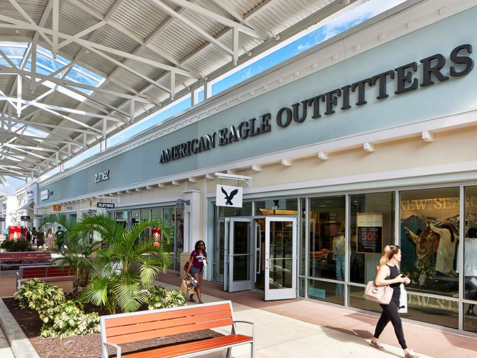 The white-washed storefronts and swaying palms create a shopping oasis that feels more vacation than errand.