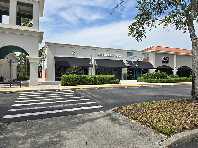 Mediterranean-inspired architecture welcomes shoppers to Vero Beach Outlets, where palm trees and terra cotta roofs create a shopping oasis rather than just another mall.