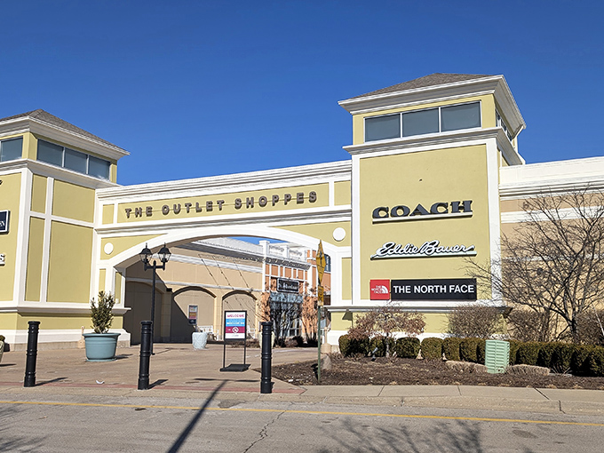 The golden facade of retail paradise beckons with promises of Coach, Eddie Bauer, and North Face treasures waiting to be discovered inside.