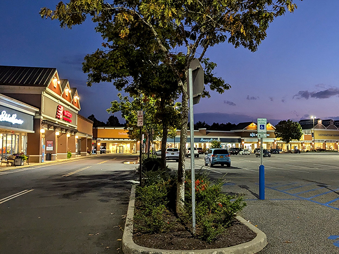 Tanger Outlets at twilight – where shopping dreams come true and credit cards get their daily exercise. The peaceful evening ambiance belies the retail frenzy within.