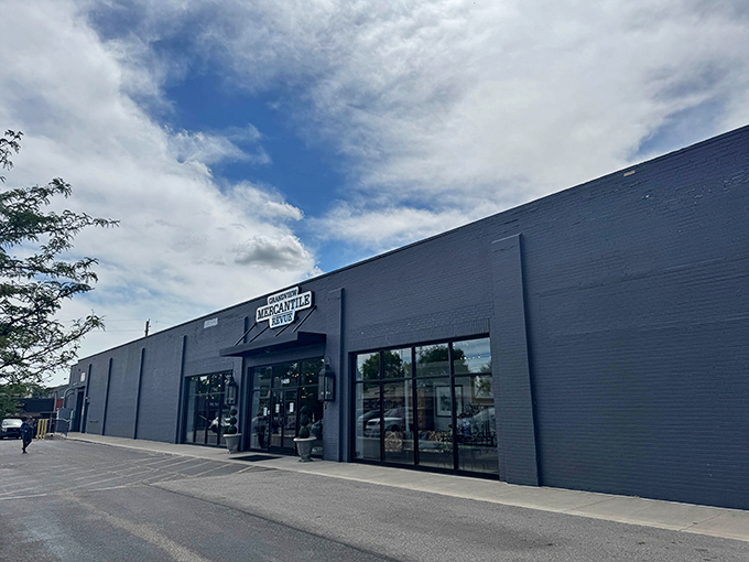 A treasure hunter's paradise where mid-century meets Victorian elegance. The polished concrete floors reflect chandeliers hanging from industrial ceilings—raw meets refined in perfect harmony.