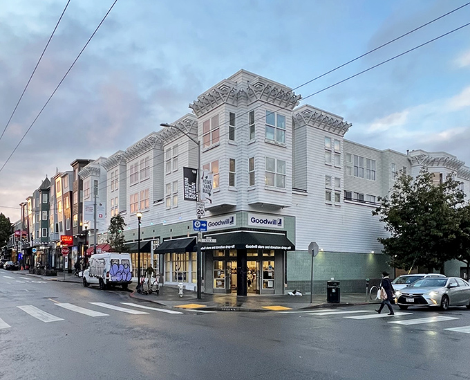 The corner Goodwill on Mission Street stands like a treasure chest disguised as a building, promising affordable adventures within its unassuming white walls.