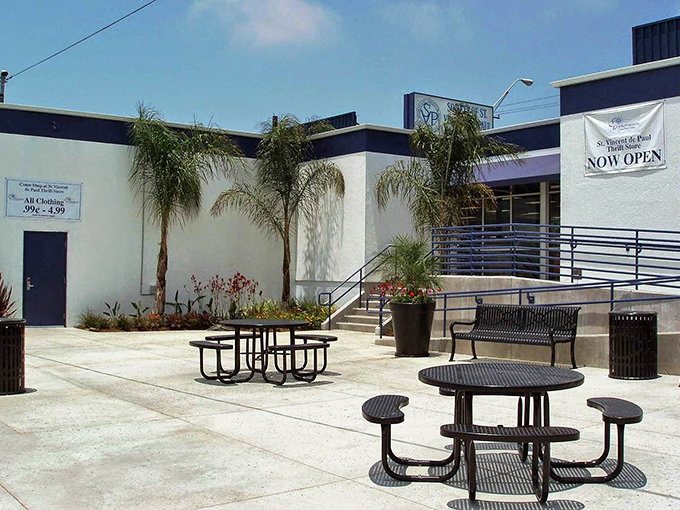 California sunshine greets thrifty shoppers at the outdoor seating area, where palm trees and picnic tables create a mini-oasis for bargain hunters.