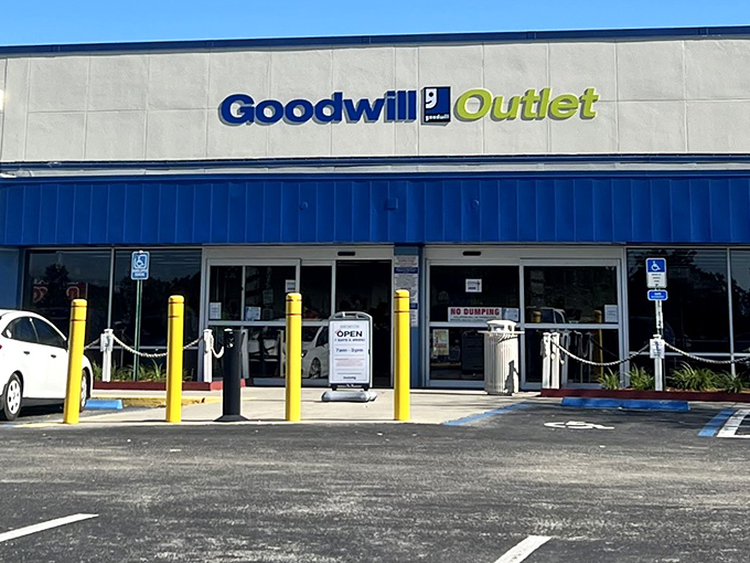 The blue-trimmed facade of Goodwill Outlet stands like a treasure chest waiting to be opened, promising adventures in bargain hunting for the curious shopper.