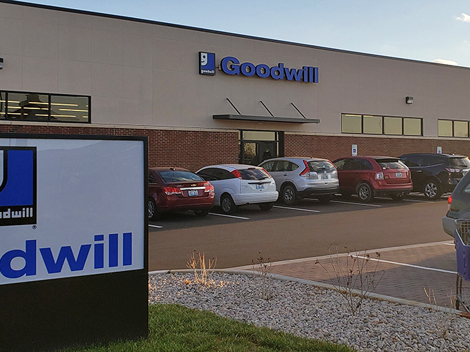 The iconic blue Goodwill sign beckons like a lighthouse for treasure hunters, promising adventures in secondhand discovery just beyond those doors.