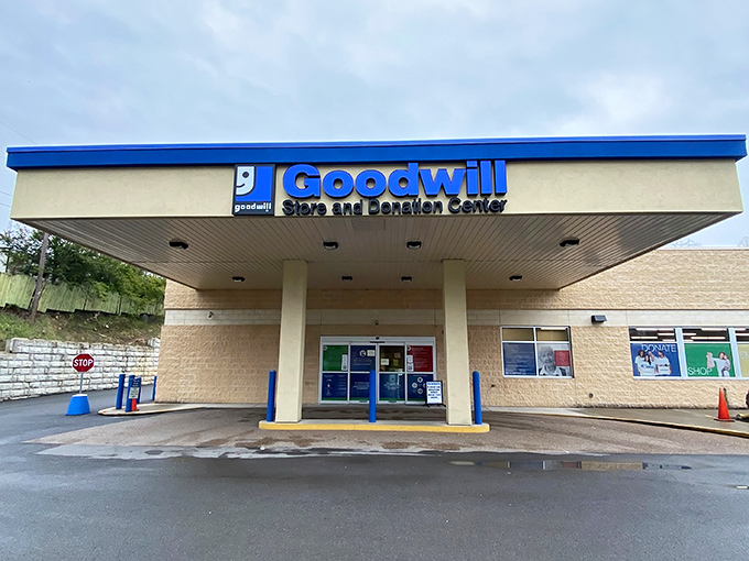 The iconic blue Goodwill sign welcomes bargain hunters like a beacon of thrifty hope. This unassuming exterior houses treasures waiting to be discovered.