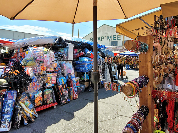 The entrance to bargain paradise! Alameda Swap Meet's outdoor section buzzes with colorful merchandise under a perfect California sky.