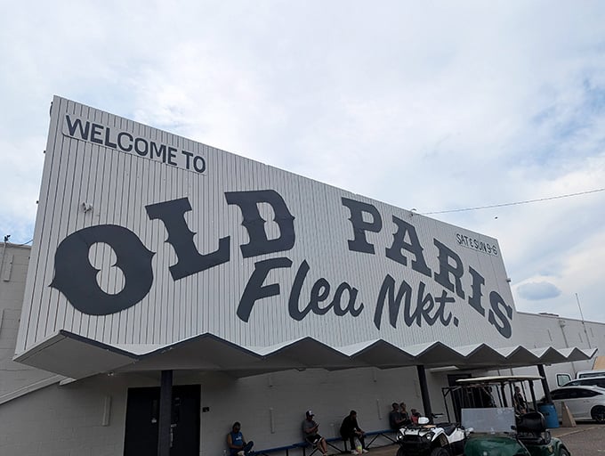 The Oklahoma City skyline watches over Old Paris Flea Market like a proud parent, its unassuming exterior hiding the treasure trove that awaits inside.