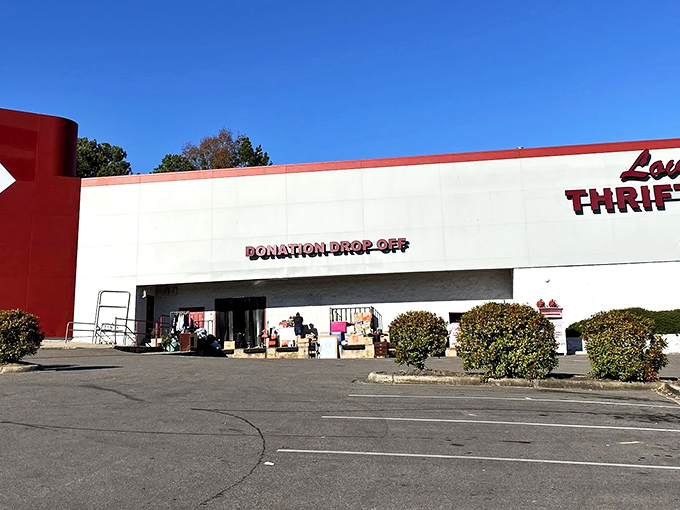 The unmistakable red exterior of Lovelady Thrift Store stands like a beacon of bargain-hunting hope against the Alabama sky, promising treasures within.