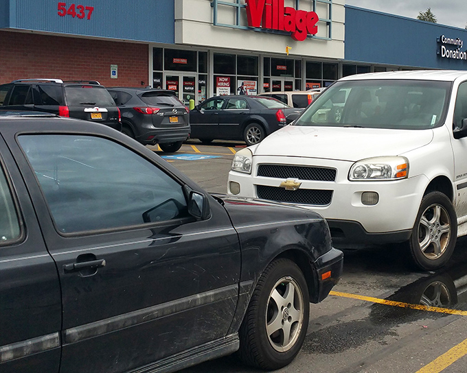 The bright red Value Village sign stands like a beacon of bargain hope against the Anchorage sky, promising treasures within for the patient hunter.