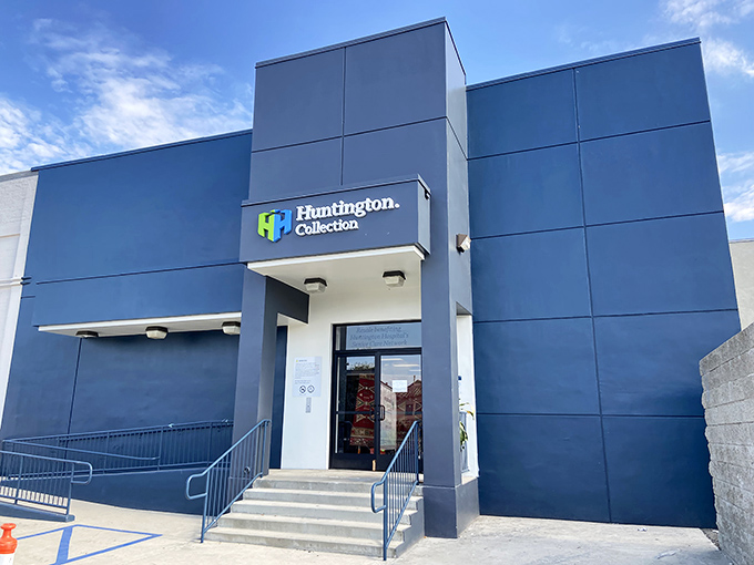 The sleek blue exterior of Huntington Collection hides a vintage wonderland inside—proof that paradise sometimes comes with a polished facade.