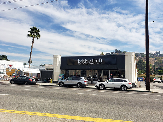 The unassuming storefront of Bridge Thrift beckons like a portal to treasure-hunting paradise, complete with quintessential LA palm tree standing guard.