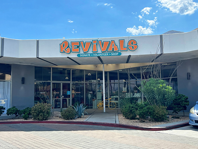 The iconic orange Revivals sign beckons treasure hunters against the backdrop of Palm Springs' blue skies and mountain silhouettes.
