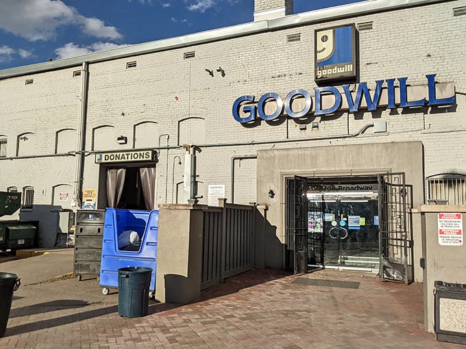 The white brick facade and bold blue signage of Goodwill Archer serves as Denver's portal to secondhand treasures and unexpected finds.