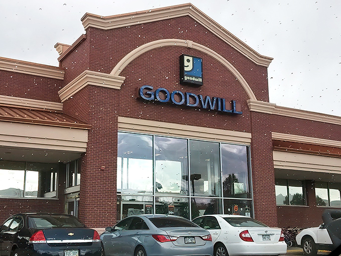 The brick facade of Goodwill beckons like a treasure chest waiting to be unlocked by savvy Colorado shoppers.
