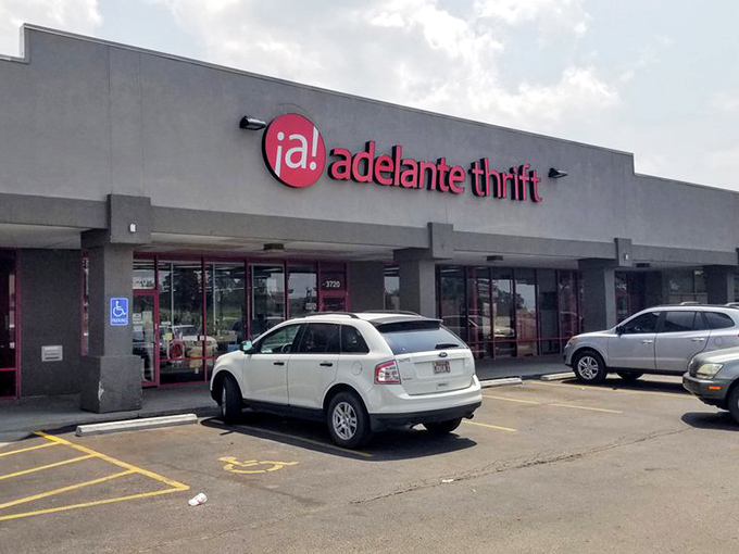 The bright red Adelante Thrift sign beckons bargain hunters like a lighthouse guiding ships to treasure-filled shores.