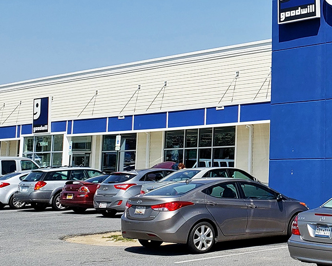 The blue and white exterior of Ellicott City's Goodwill beckons like a retail oasis, promising treasures waiting to be discovered inside. A full parking lot tells the story of Maryland's favorite thrifting destination.