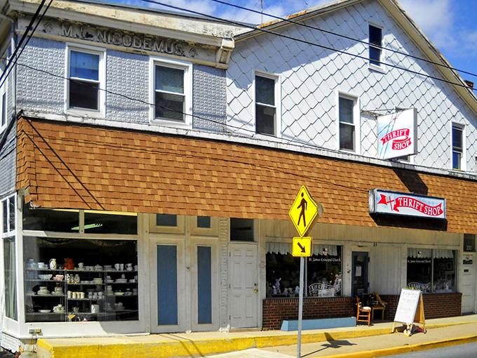 The historic Nicodemus Building houses St. James Thrift Shop, where diamond-patterned siding and cedar shakes whisper tales of treasures waiting inside.