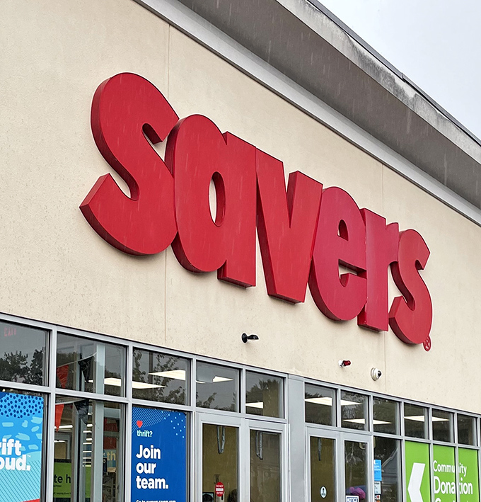 The iconic red Savers sign beckons like a lighthouse for bargain hunters, promising shores lined with secondhand treasures waiting to be discovered.