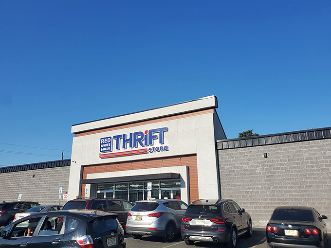 The unassuming exterior of Red White & Blue Thrift Store stands like a treasure chest waiting to be opened, promising bargain-hunting adventures under the bright New Jersey sky.
